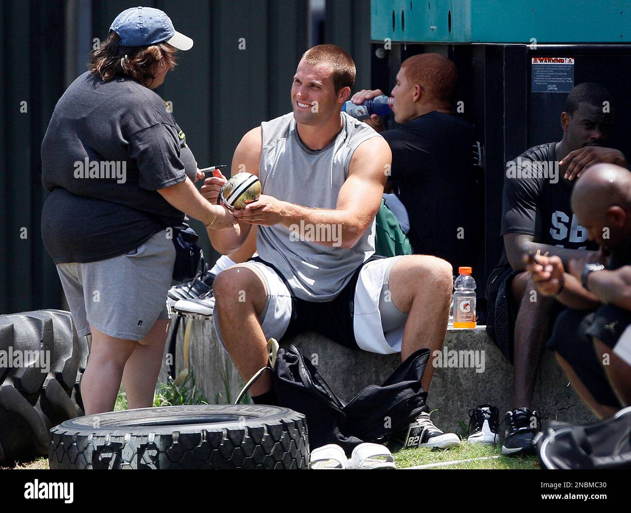 New Orleans Saints tight end Tyler Lorenzen, center, signs an autograph ...