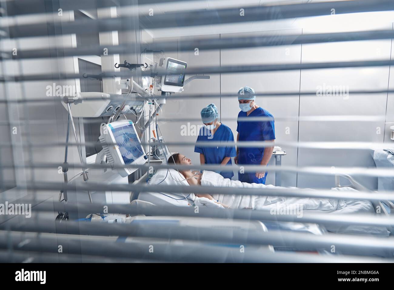 Intensive care unit. doctor and nurse caring for female patient in ...