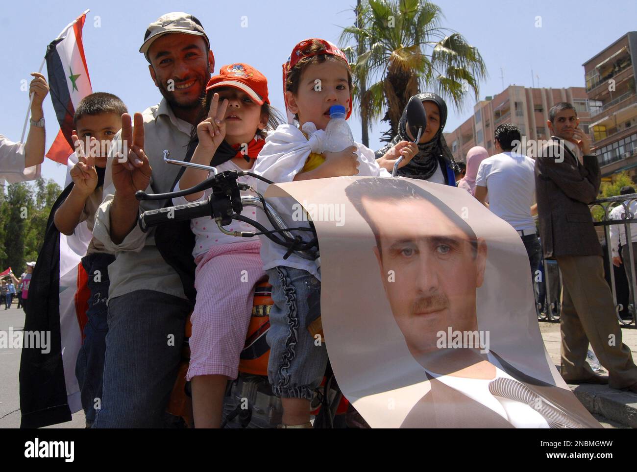 A supporter of Syrian President Bashar Assad, picture shown, rides his ...