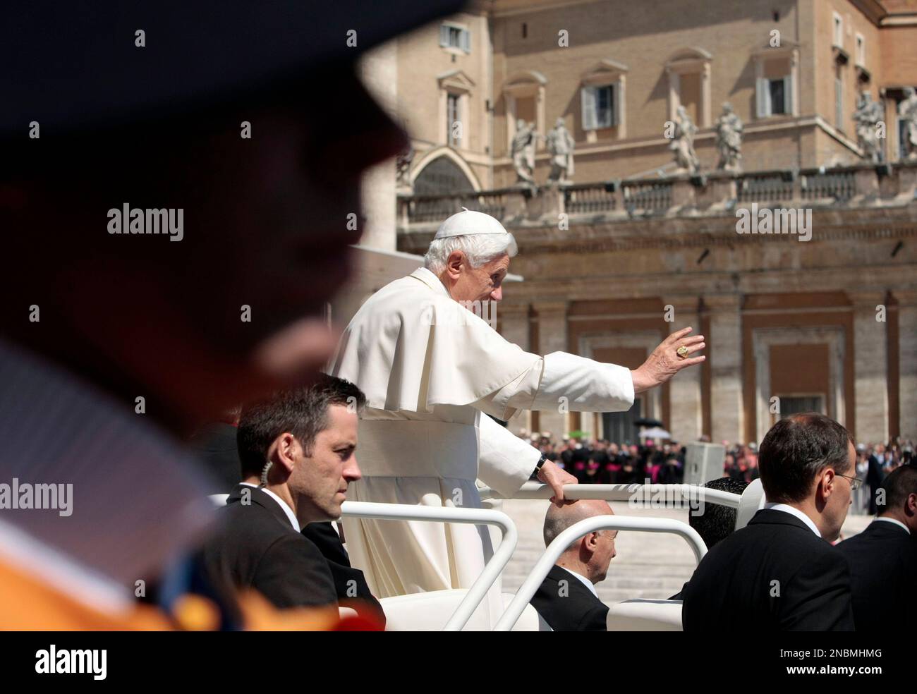 Pope Benedict XVI waves to faithful as he arrives for his weekly ...