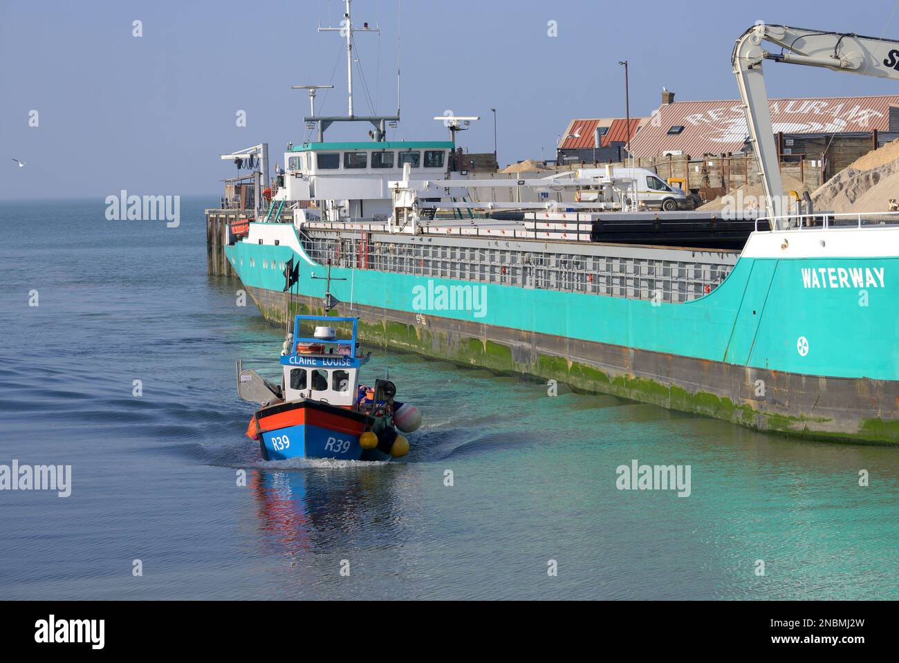 Whitstable, Kent, England, UK. Small fishing boat entering the harbour ...