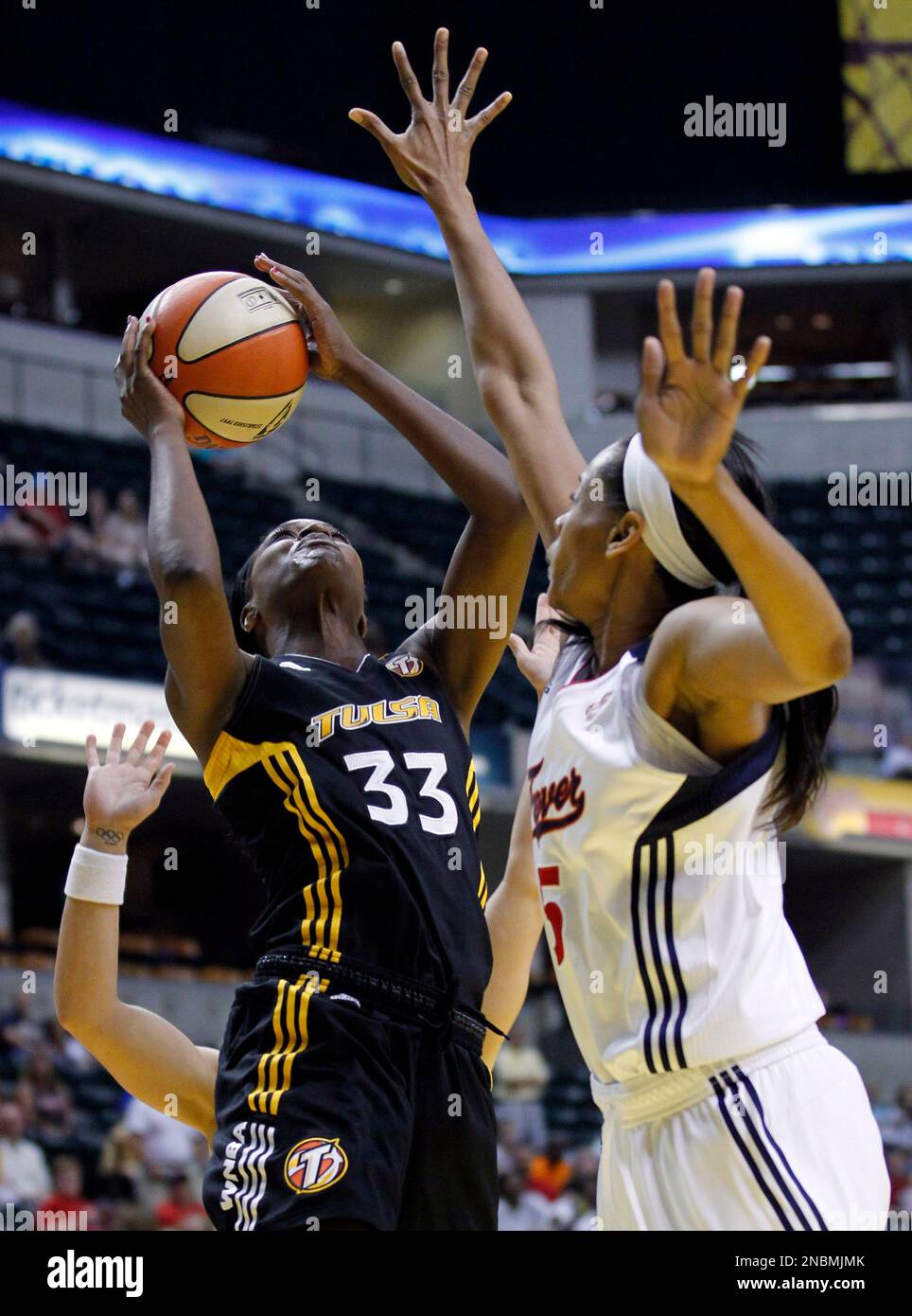 Tulsa Shock forward Tiffany Jackson, left, shoots under pressure from ...