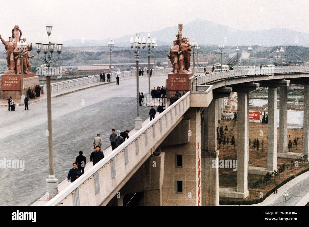Pedestrians cross a dual carriage bridge over the Yangtze River at ...