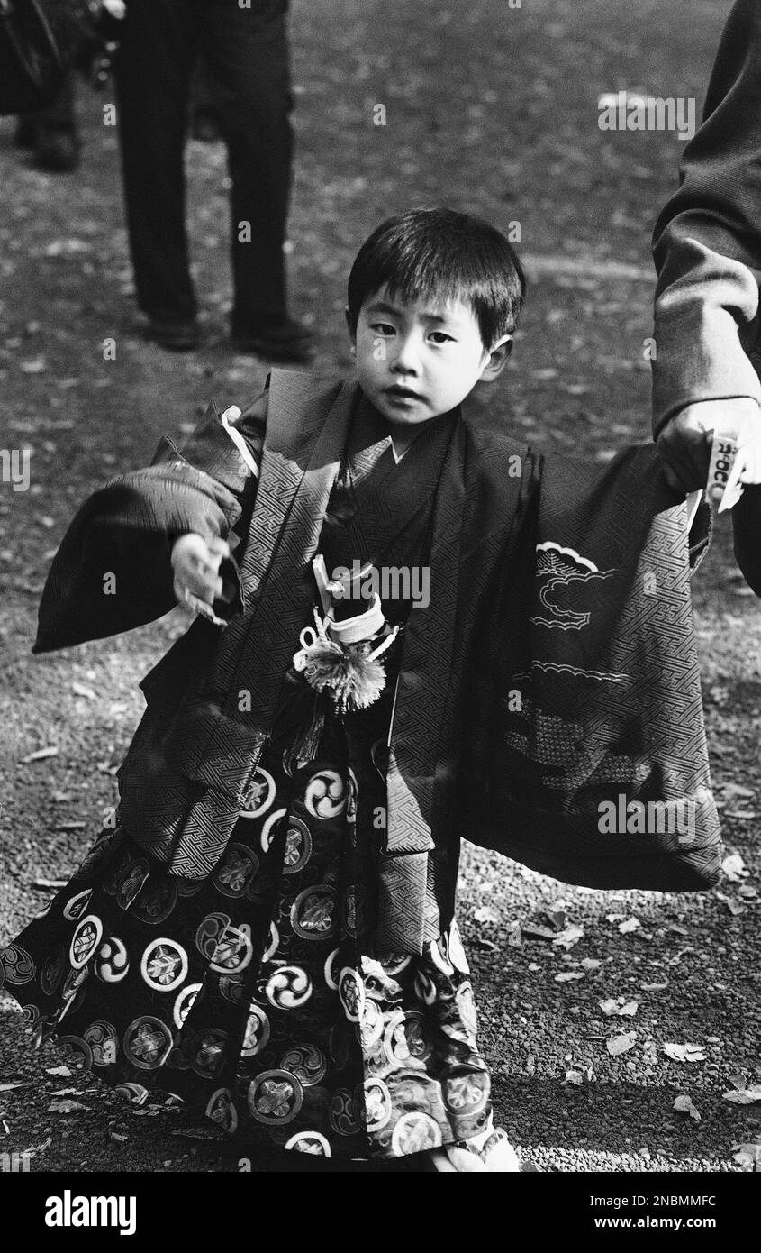 Standing holding hands looking at camera childhood traditional culture ...