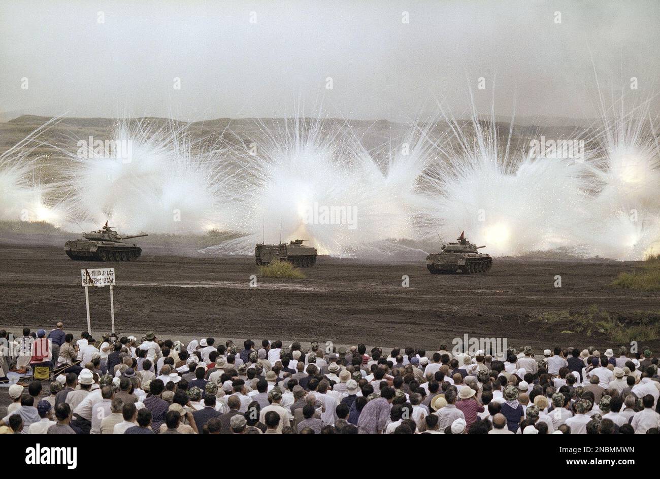 Tanks of Japan’s Self Defense Forces maneuver behind smoke bombs during ...