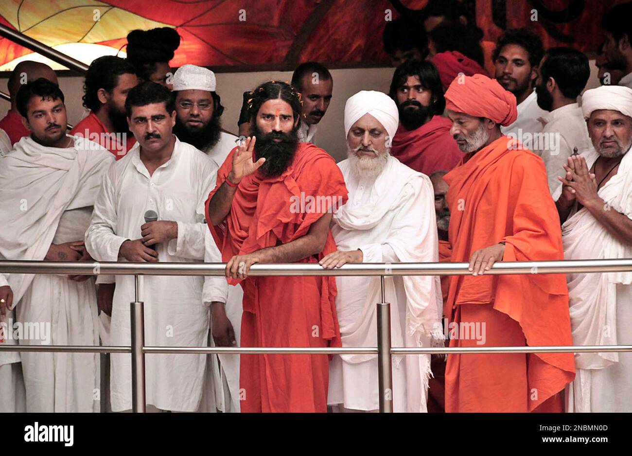 Indian yoga guru Baba Ramdev, center, gestures upon arrival at his ...