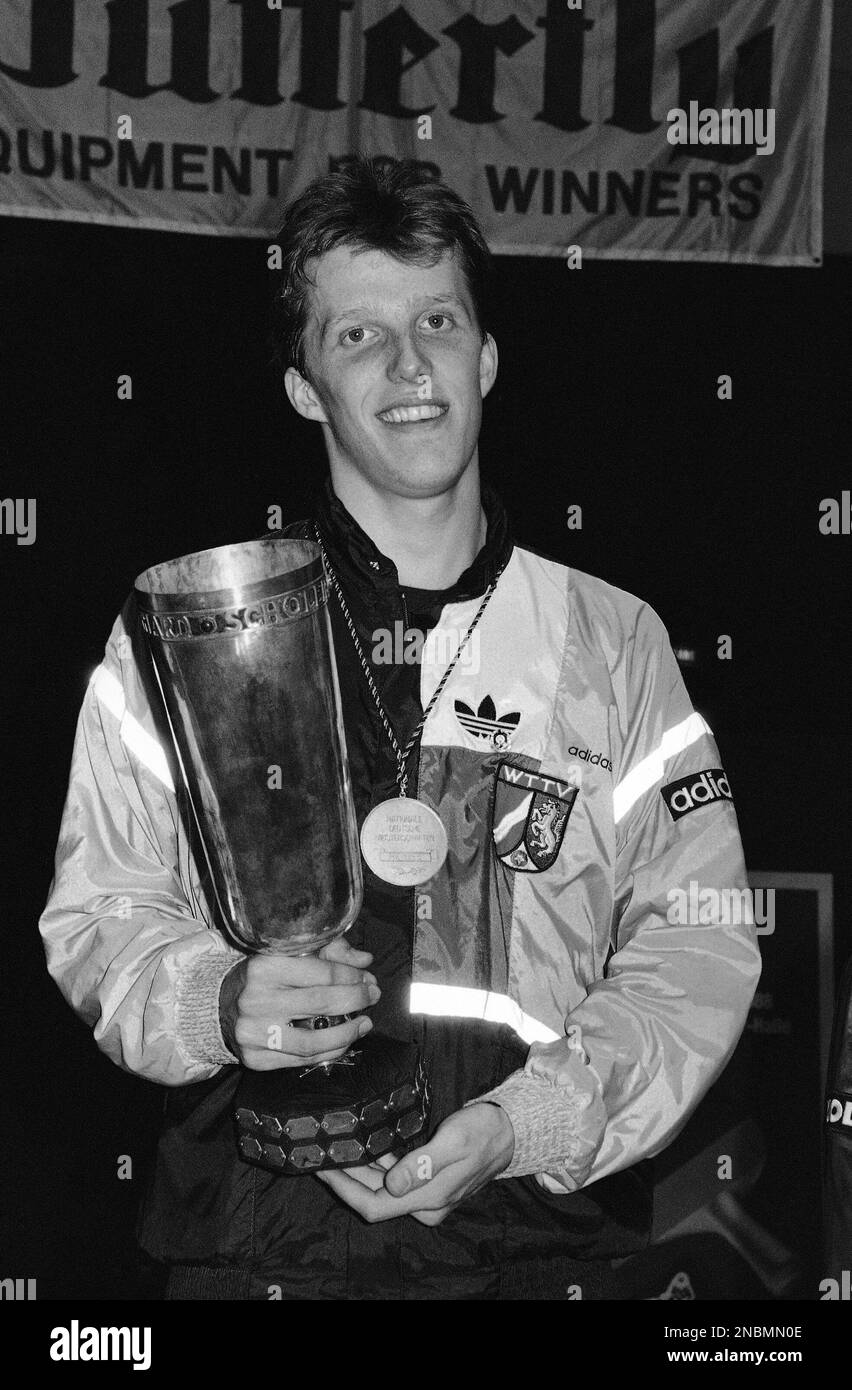 German player Joerg Rosskopf smiles while holding the trophy after his ...