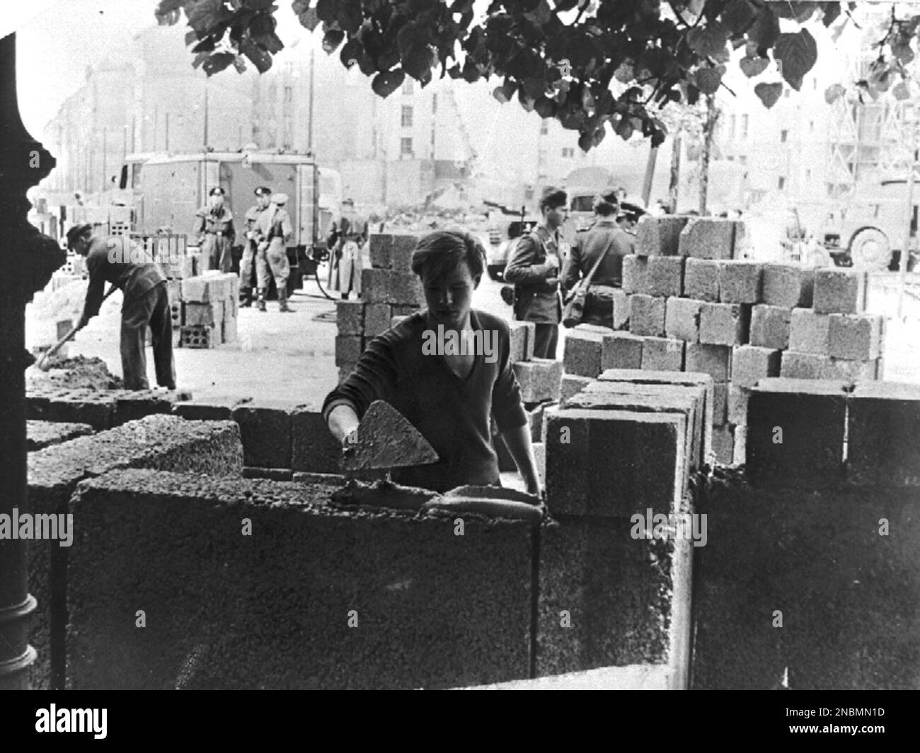 FILE - In this Aug. 1961 file photo, an East German worker lays some of ...