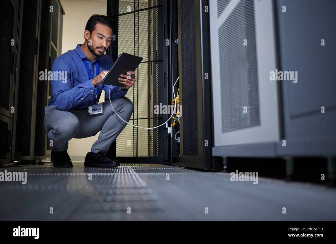 Engineer, server room and man with tablet for database connection cable ...