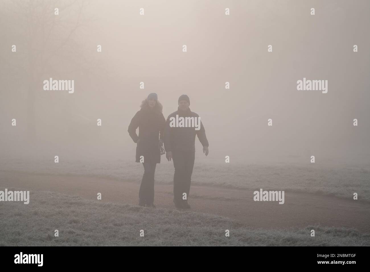 London, UK. 14 February 2023. Walkers brave the dense fog and frosty ...