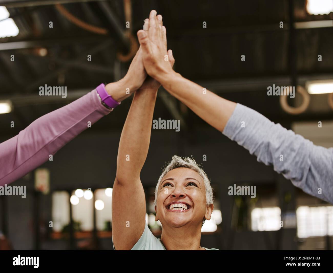 Fitness, teamwork and high five of senior women in gym celebrating ...