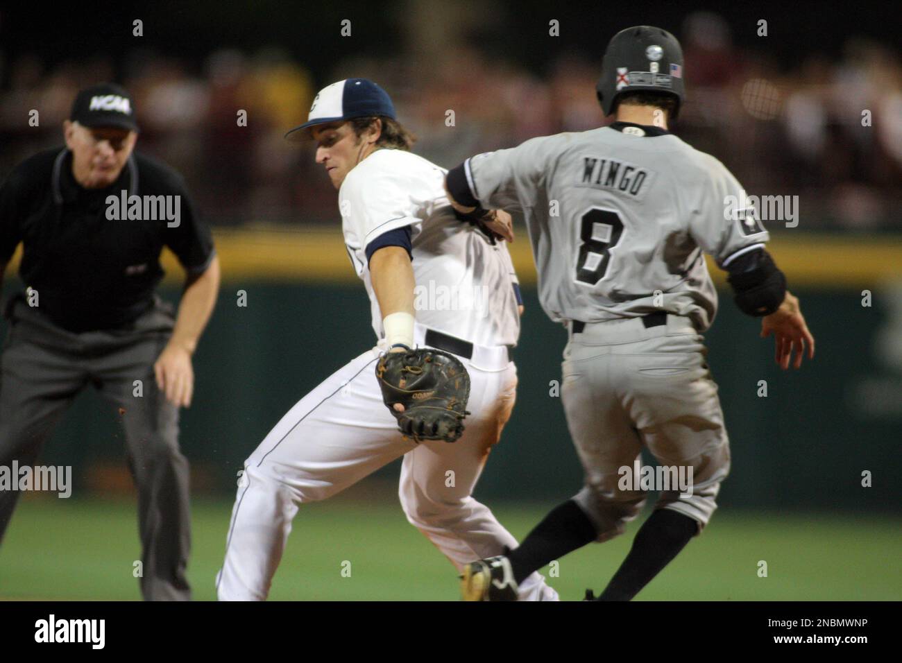 South Carolina's Scott Wingo (8) pushes Connecticut first baseman Mike ...