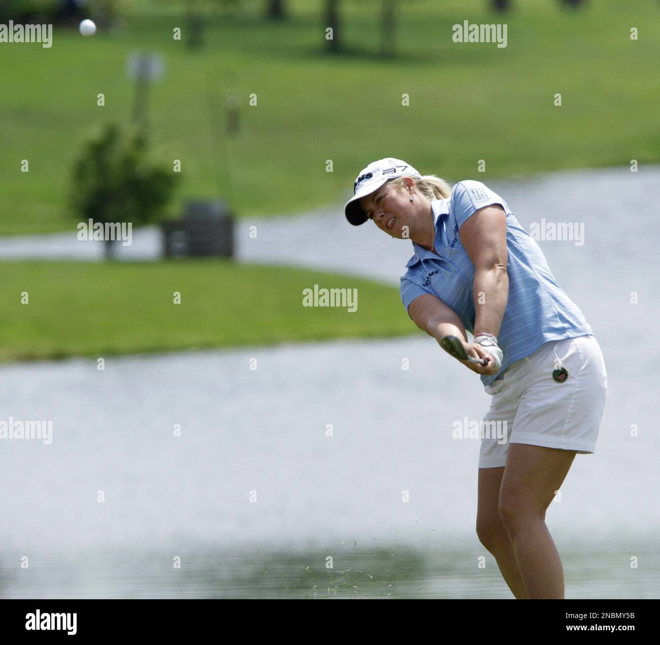 Brittany Lincicome hits the ball out of the rough onto the ninth green ...