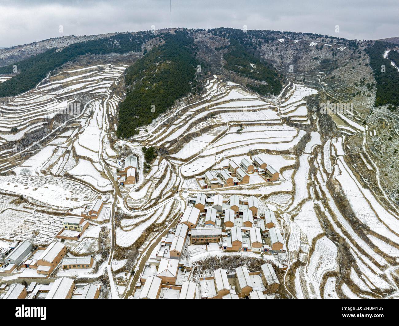 Aerial photo shows snow-covered village around the Taihang Mountains in ...