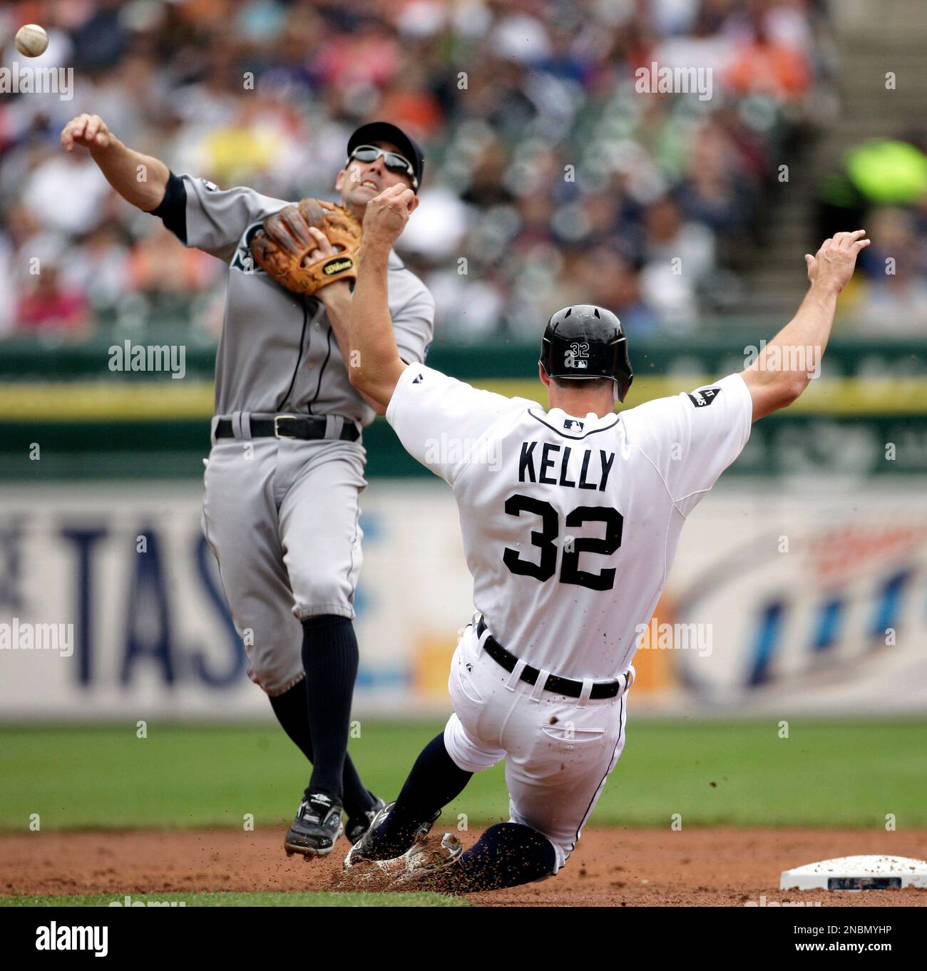Seattle Mariners second baseman Jack Wilson, left, turns the ball after ...