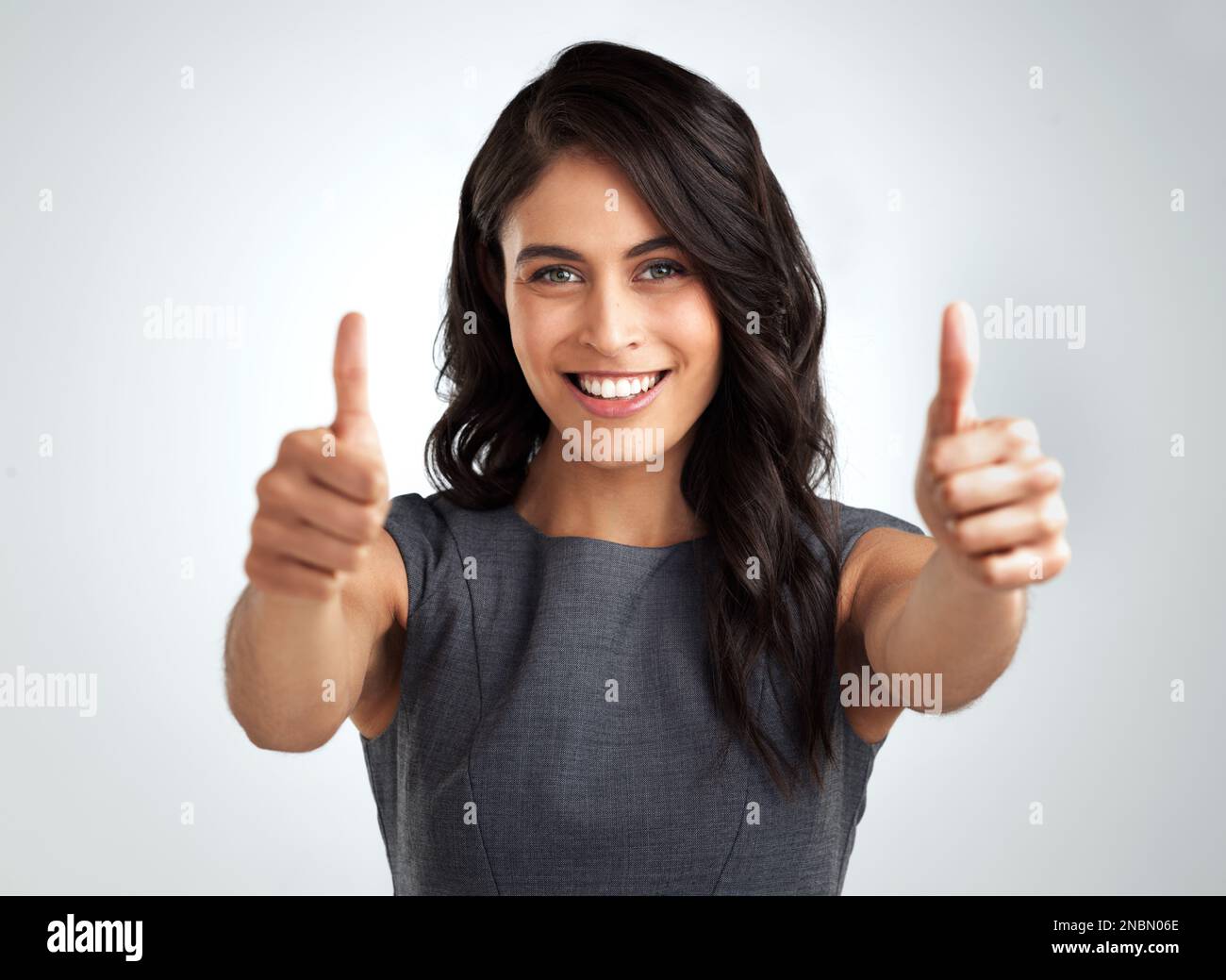 Im really impressed. a young woman showing thumbs up while standing ...
