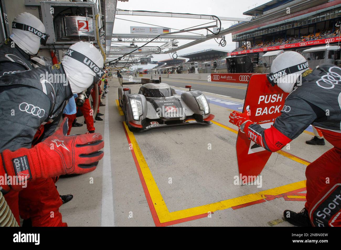 The Audi R18 No2 driven Andre Lotterer of Germany arrives in the pits ...