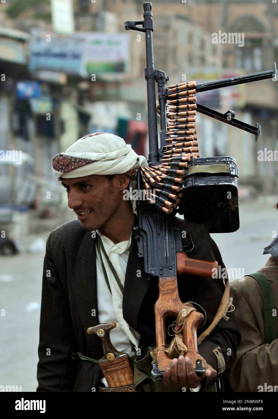 An armed tribesman, loyal to Sheik Sadeq al-Ahmar, the head of the ...