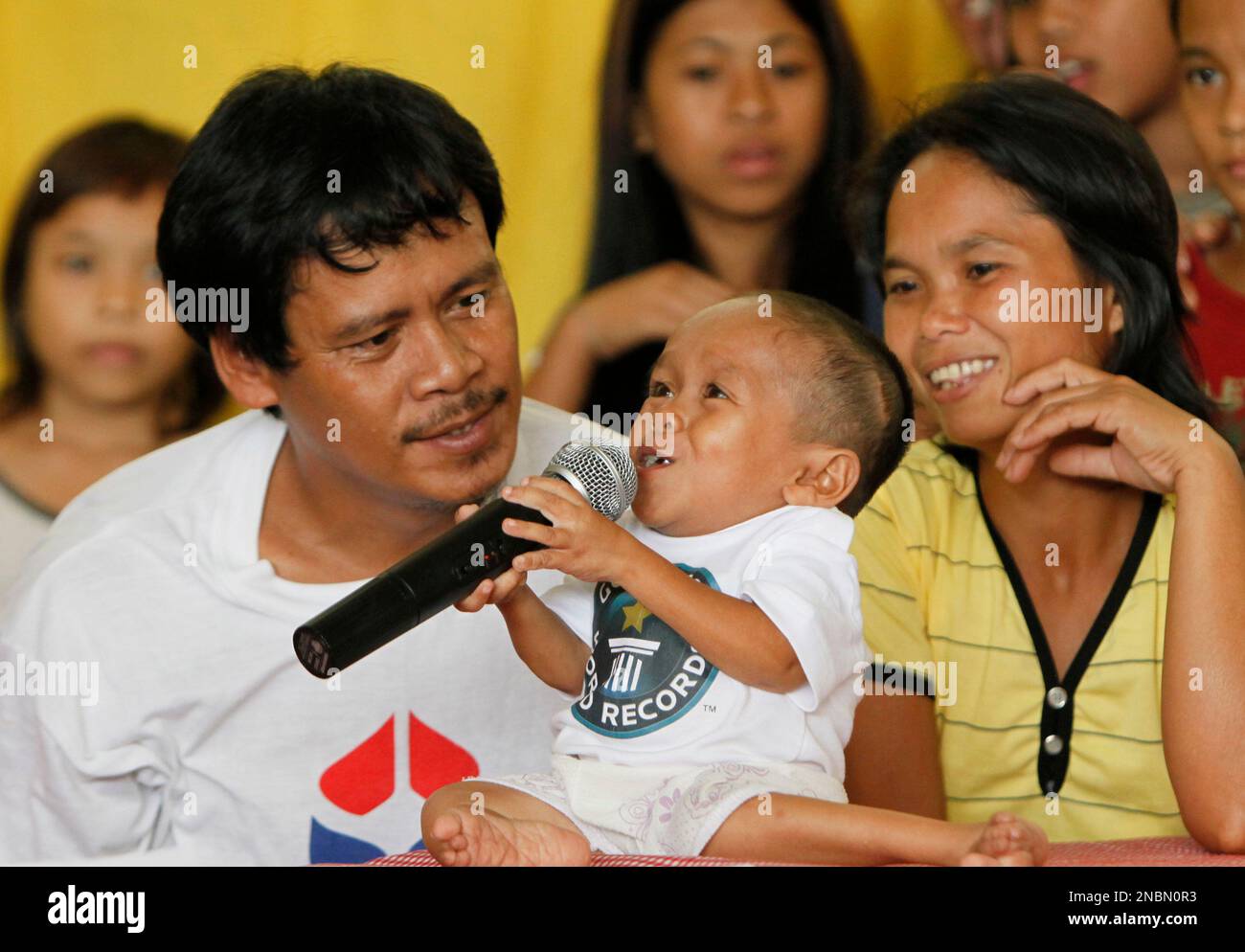 Reynaldo, left, and Concepcion Balawing, parents of Junrey Balawing, center, react as Junrey ...