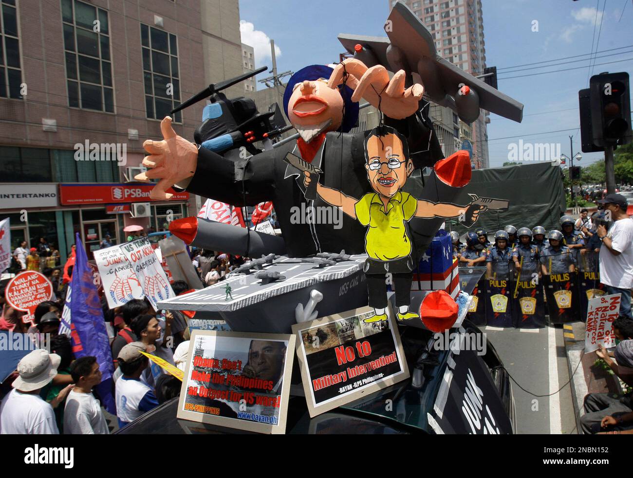 An effigy of Uncle Sam holding a puppet of Philippine President Benigno ...