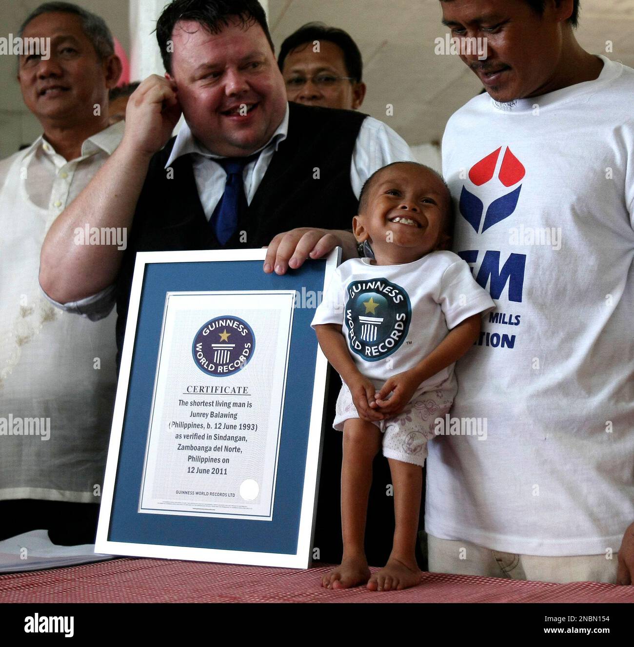 Junrey Balawing smiles as he is presented by Craig Glenday, second from ...