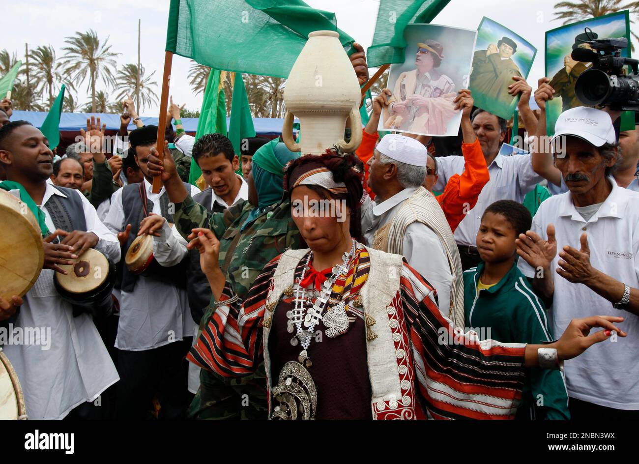 Libyans dance carrying pictures of Libyan leader Moammar Gadhafi as ...