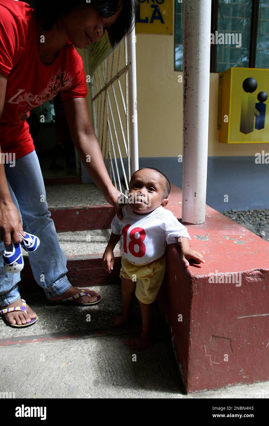 Junrey Balawing is assited by his mother Concepcion following a series of measurement conducted ...