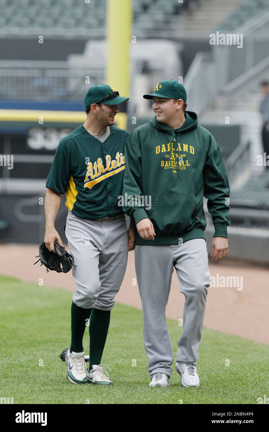 Oakland Athletics' Adam Rosaies, left, talks to Brian Fuentes as they ...