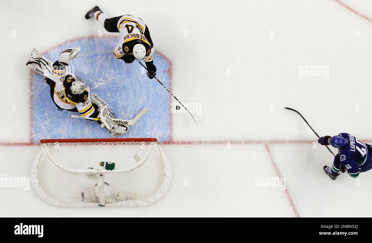 Vancouver Canucks right wing Maxim Lapierre (40) shoots to score ...