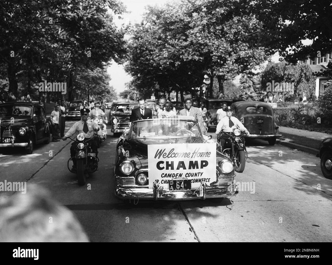 Heavyweight boxing champion Joe Walcott waves to cheering crowds in his ...