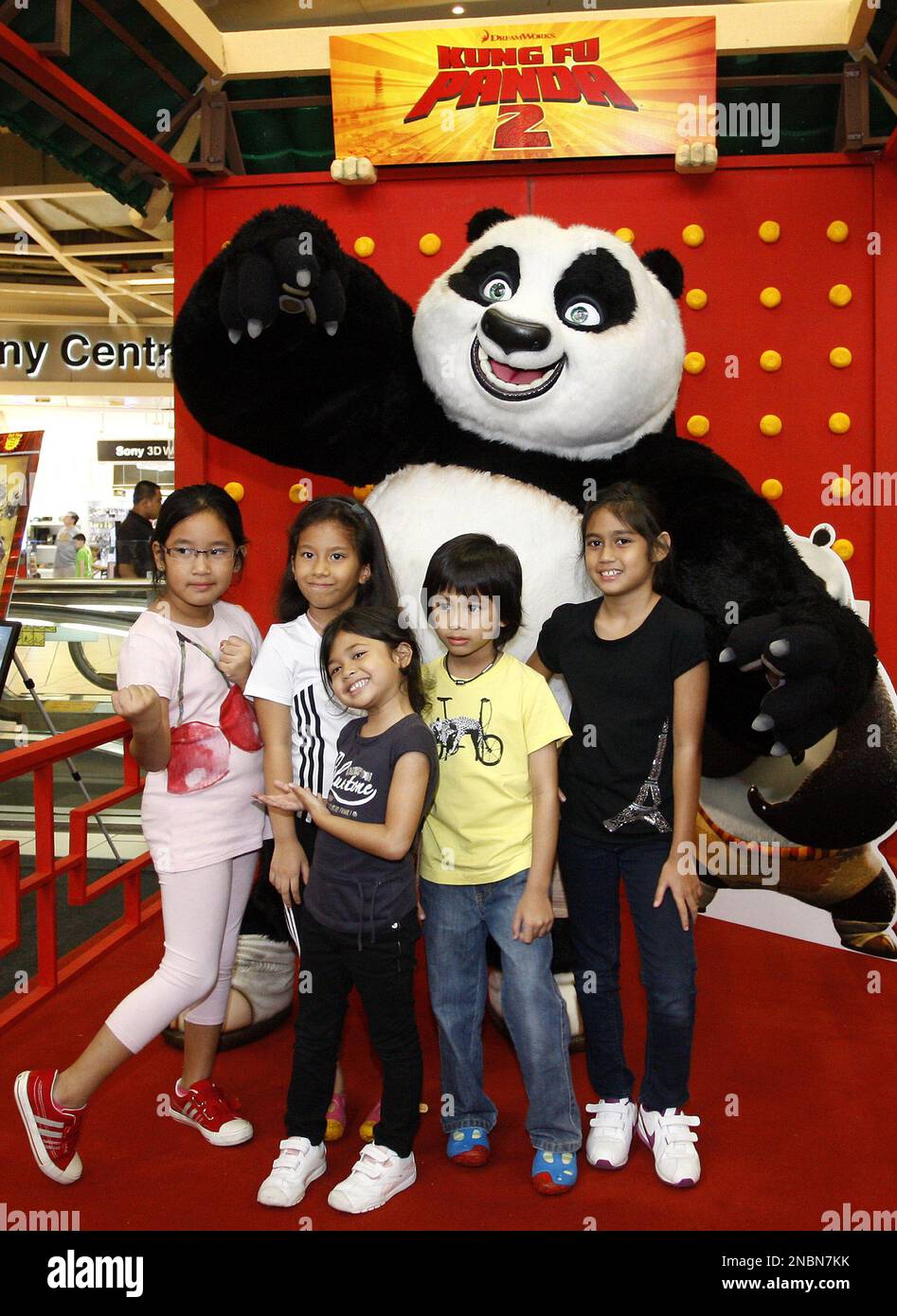 Children pose for a photo with "Kung Fu Panda" movie character Po at a ...