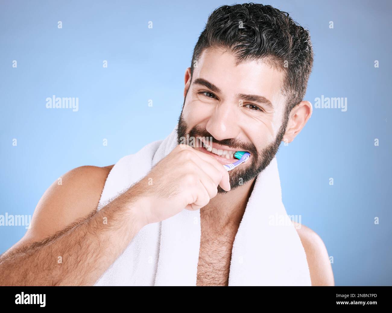 Toothbrush, portrait and man brushing teeth in studio for dental wellness, healthy smile and ...