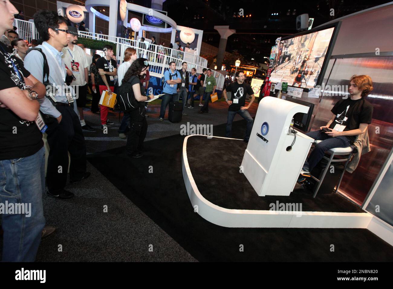 Guests play Assassin's Creed Revelations at the Ubisoft booth at the ...