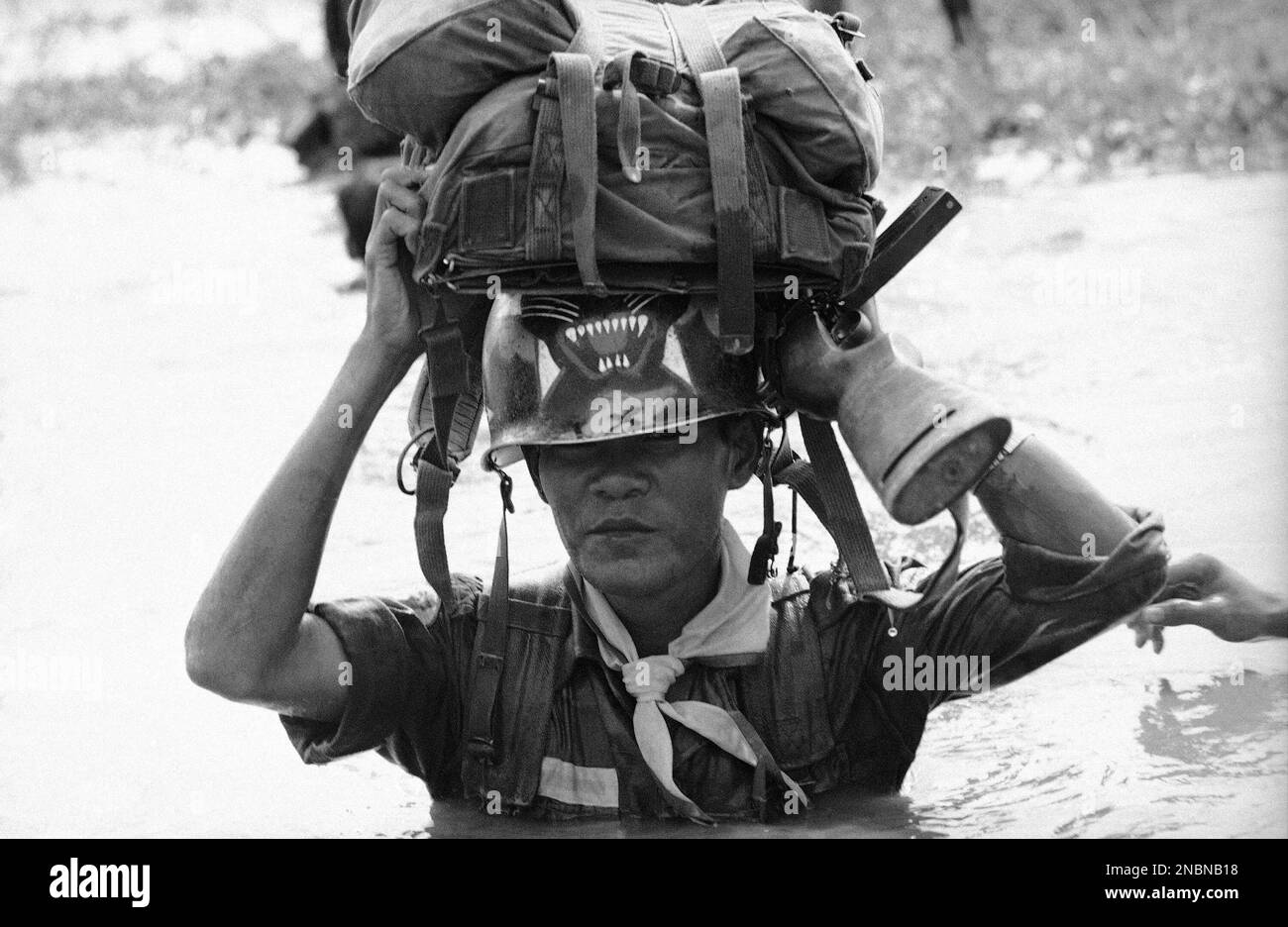 A South Vietnamese Ranger carries his backpack on his head while ...