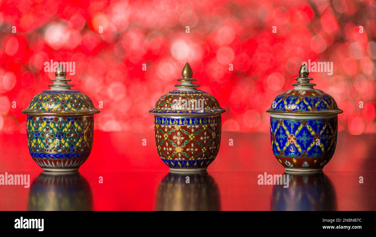 A closeup of old colorful thai porcelain with designs in five colour ...