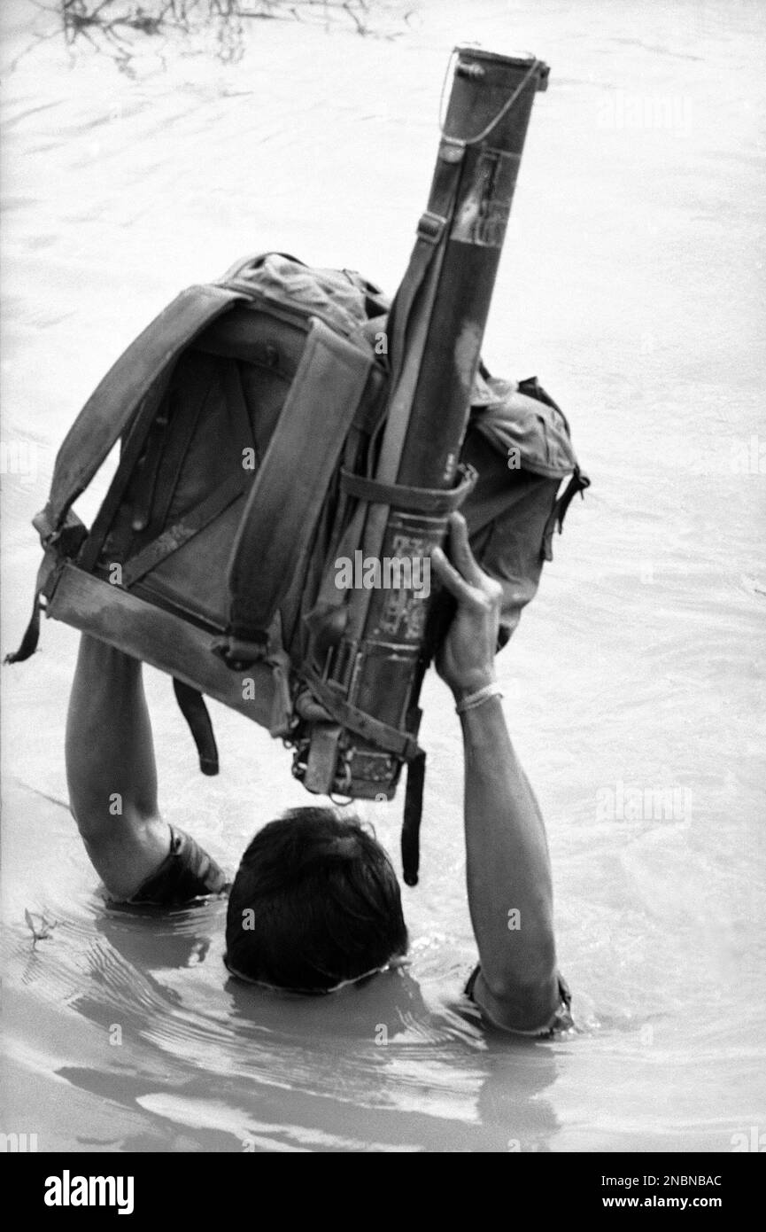 Vietnamese Ranger becomes a submariner as he walks through a canal in ...