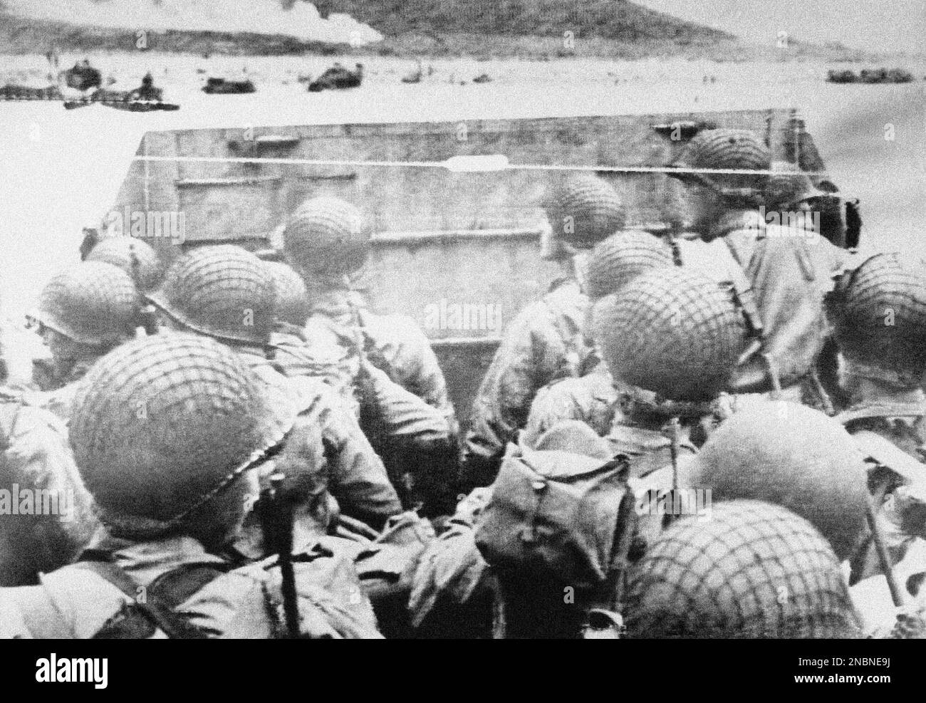 Standing behind the protective cover of their landing craft bow door ...