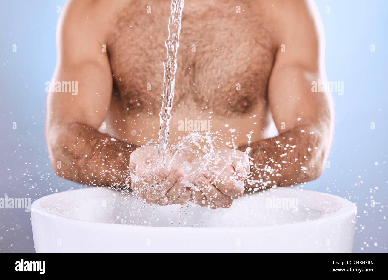 Water splash, hands and man in studio for skincare, wellness or ...