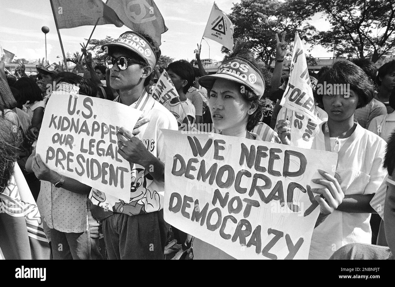 Supporters of ousted President Ferdinand E. Marcos holding placards ... Supporters of ousted President Ferdinand E. Marcos holding placards ...