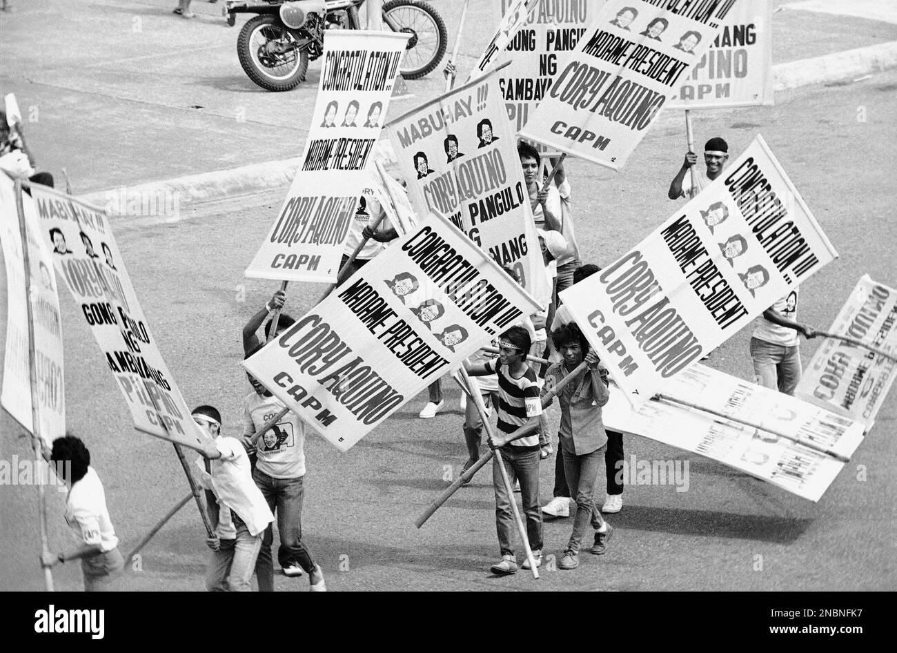 Supporters of Philippine President Corazon “Cory” Aquino arrive with ...