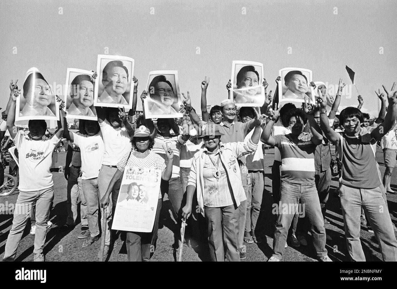 Supporters carry portraits of ousted President Ferdinand E. Marcos ...