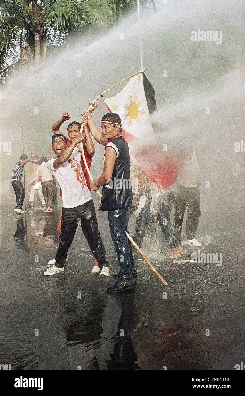 Loyalists for ousted President Ferdinand Marcos hold a Philippine flag ...