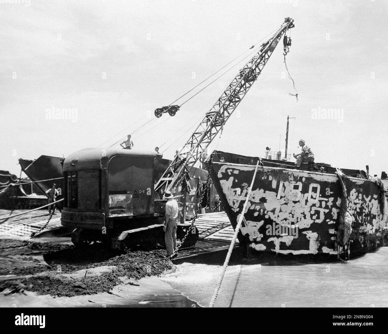 In this image provided by the U.S. Navy, the crane as it hoists the ...