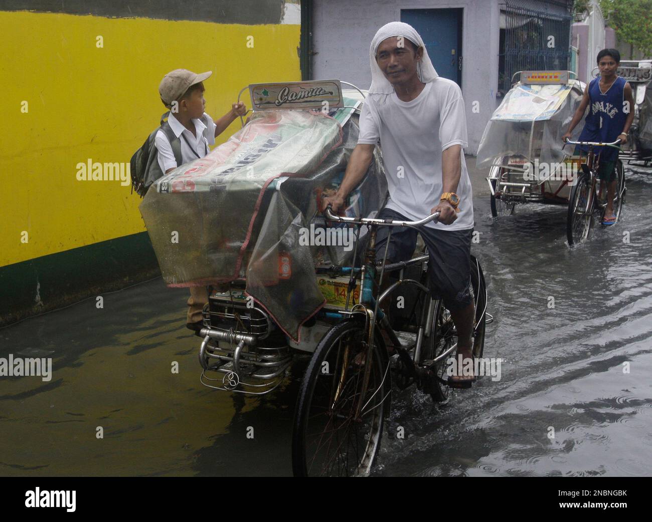 Tricycle drivers make a brisk business from commuters on a flooded ...