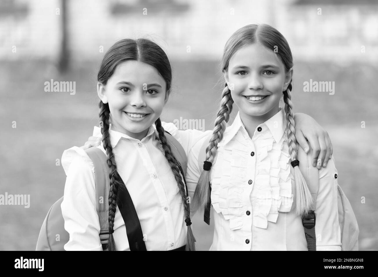 happy children hug together in school uniform with backpack Stock Photo ...
