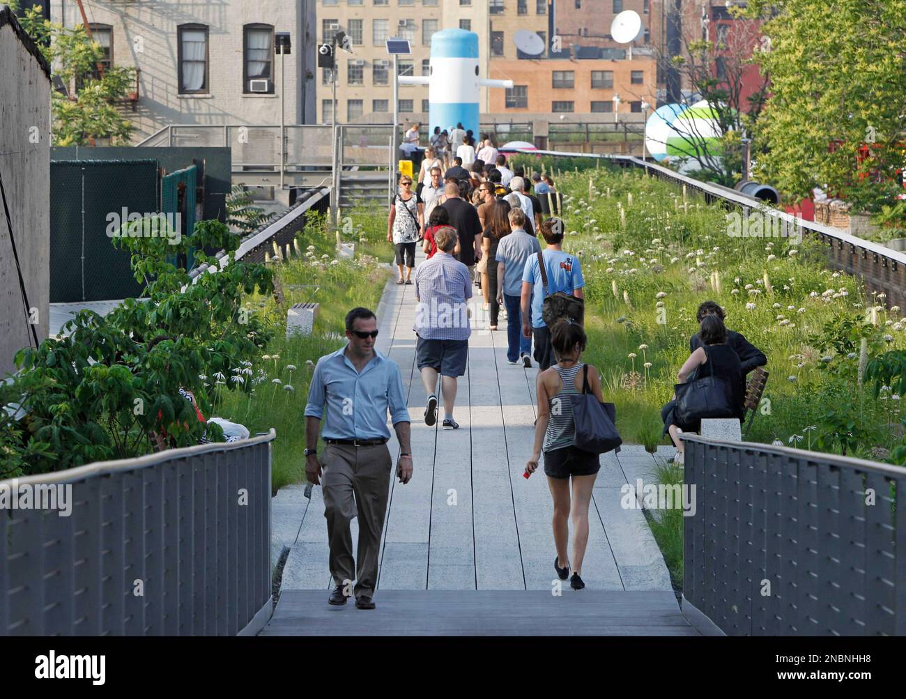 Visitors stroll down a walkway after the second section of the High ...