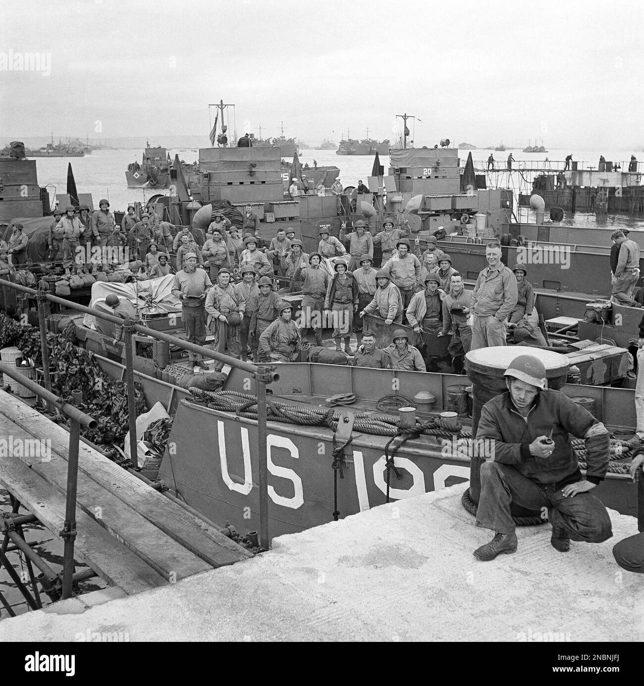 Activity at a British port as American troops embark in landing craft ...