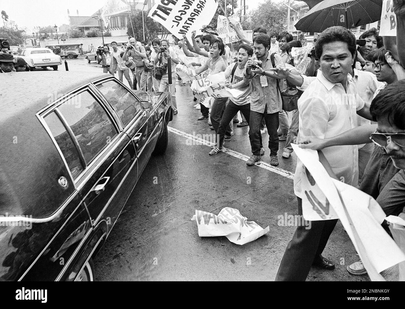 Demonstrators yell at a car leaving Malacanang Palace in Manila on ...