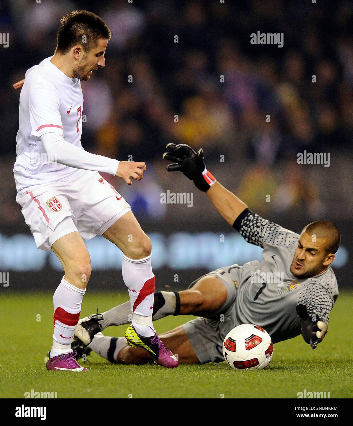 Australian goal keeper Adam Federici, right, saves a goal against ...