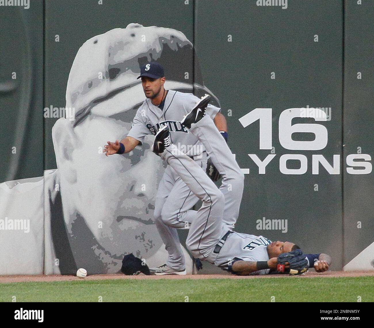 Seattle Mariners center fielder Greg Halman, right, is unable to catch ...